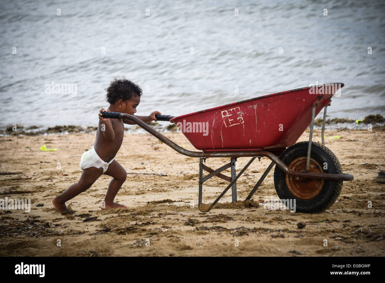 Solevu Village, Malolo Islands, Fiji. 5th Feb, 2015. A child pushes a ...