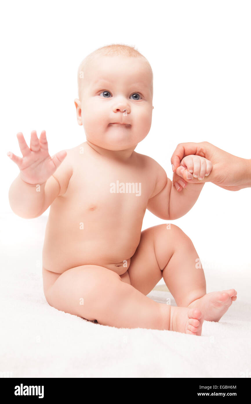 small child sits, hand helping him Stock Photo - Alamy