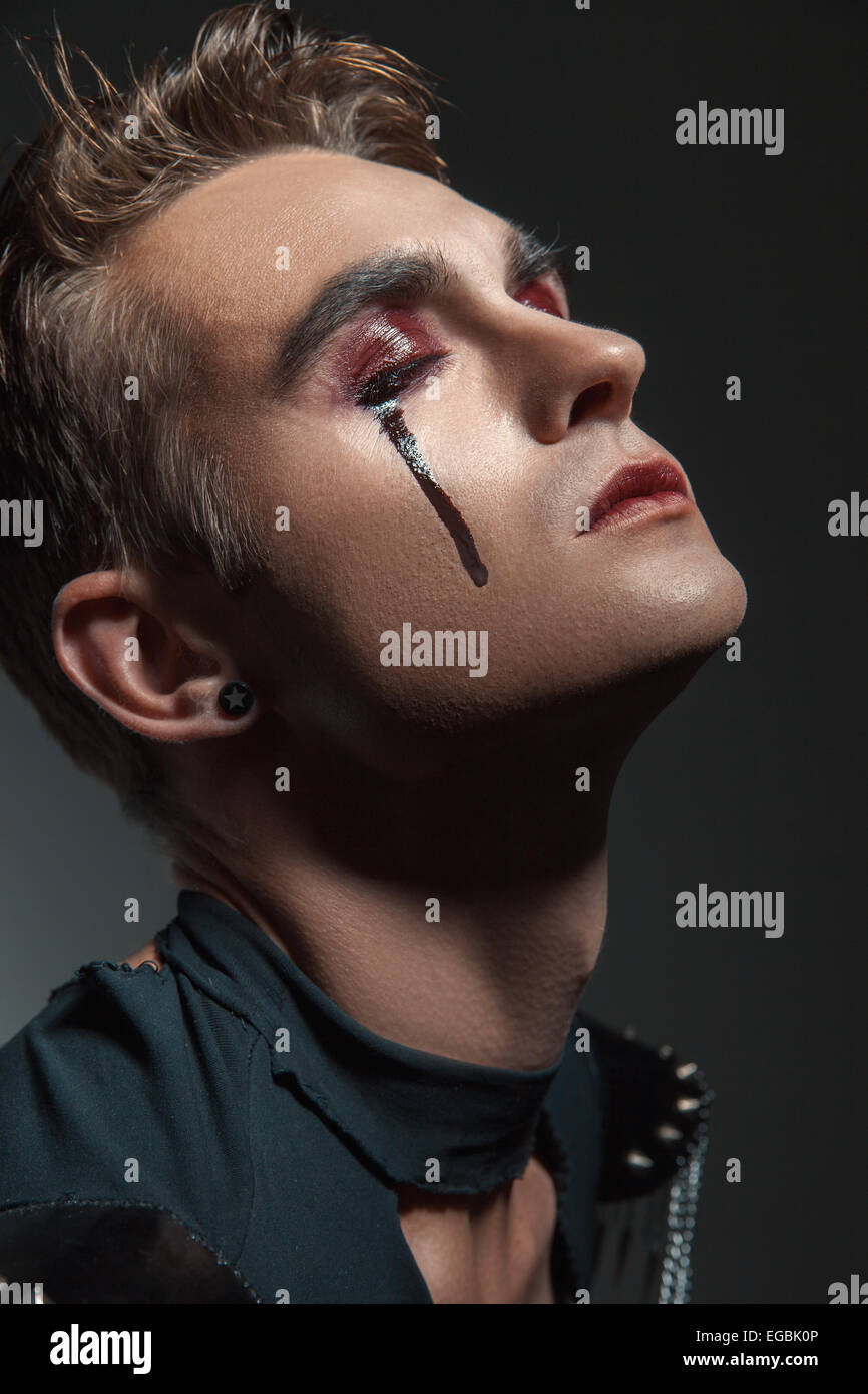 Young man with make up and painted tears Stock Photo - Alamy