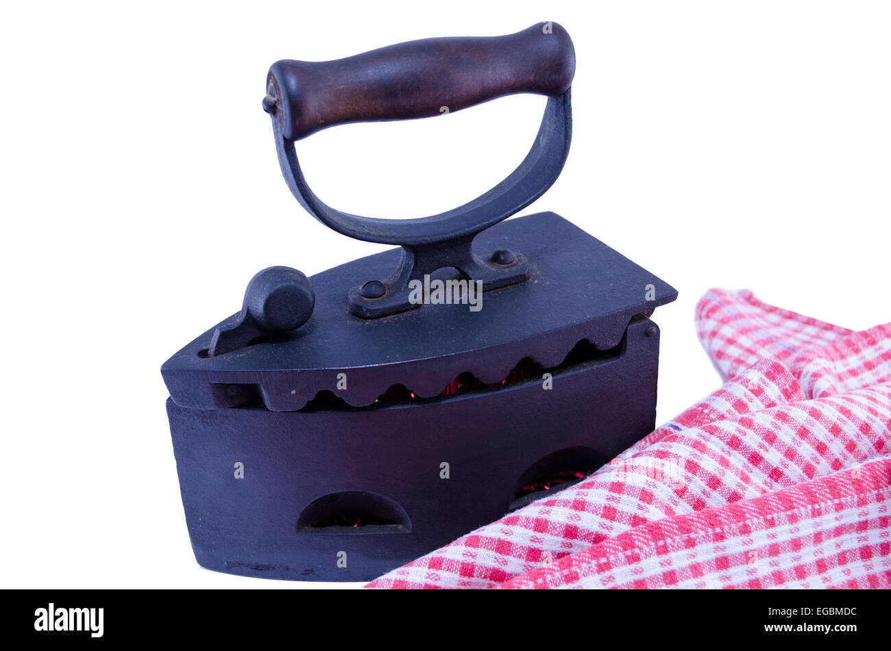 Coal iron with burning embers inside placed next to a plaid cloth ...