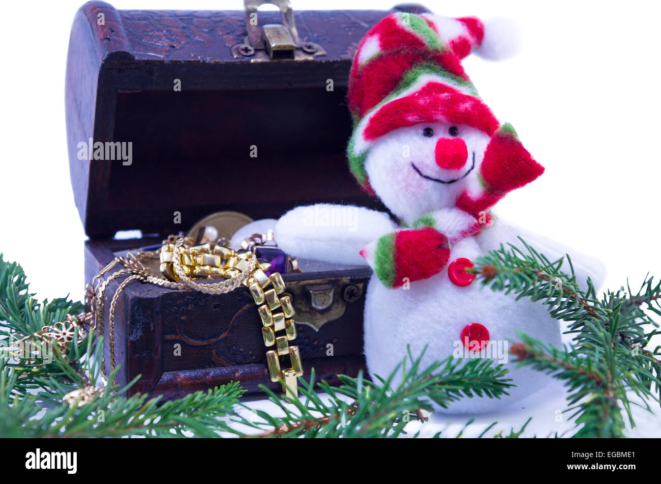 Snowman and a treasure chest full with jewelry isolate on white ...
