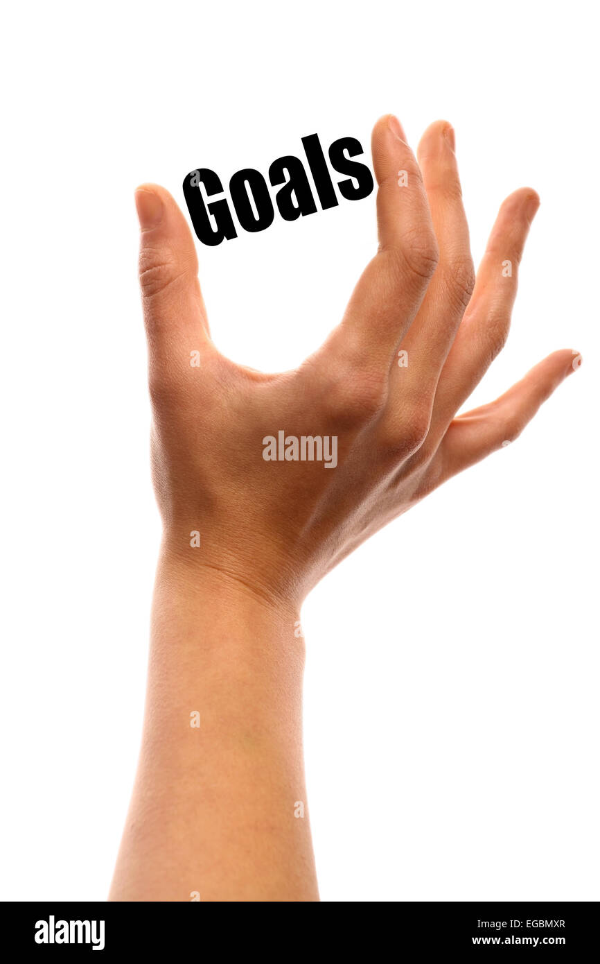 Vertical shot of a hand holding the word "Goals" between two fingers ...
