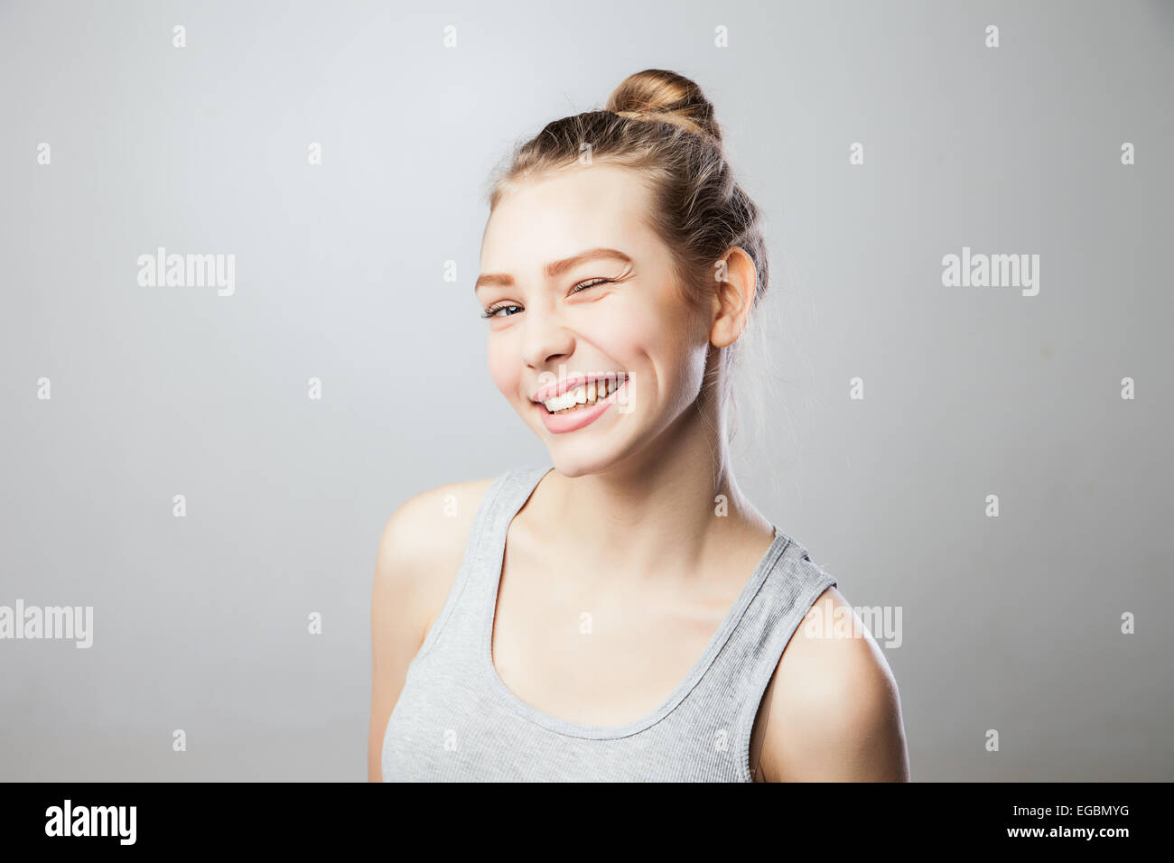 Closeup of a beautiful young woman winking Stock Photo - Alamy