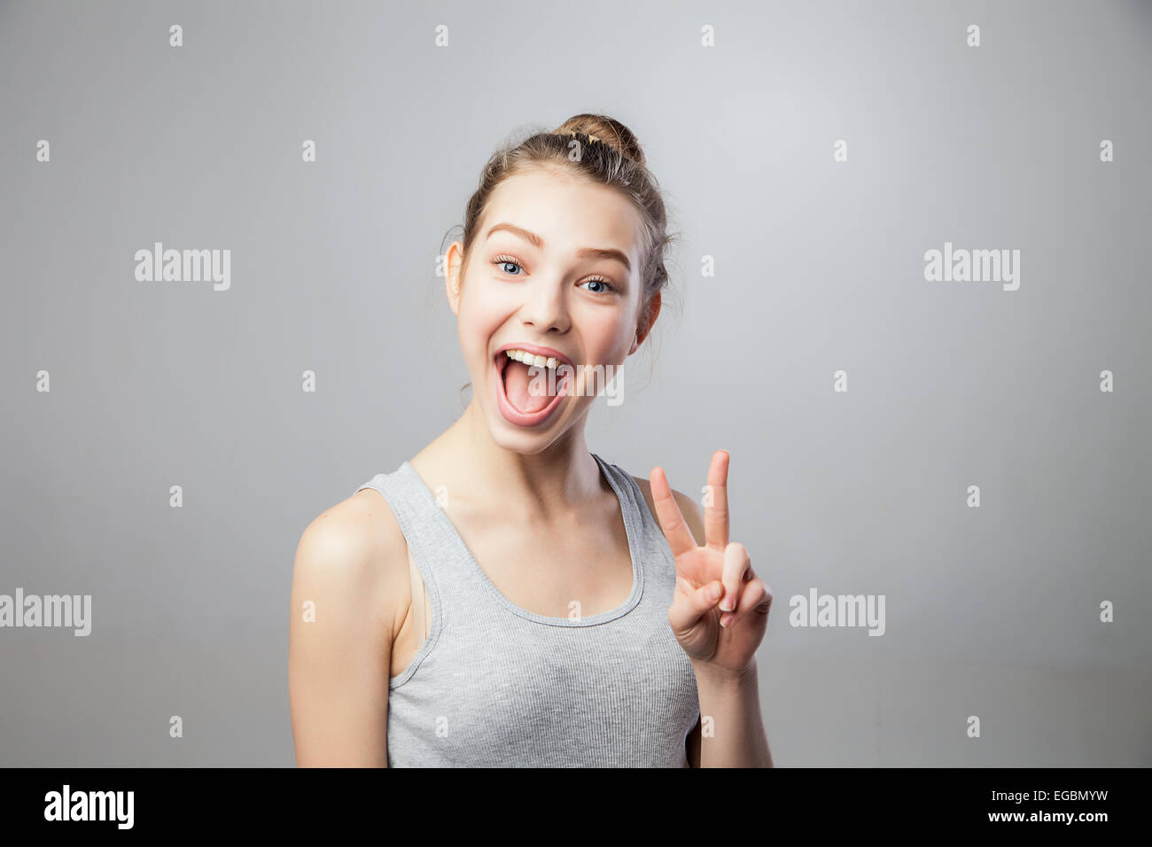 Closeup portrait young woman showing v sign Stock Photo - Alamy