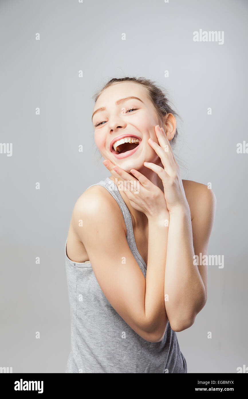 pretty young excited woman, isolated against grey background Stock ...