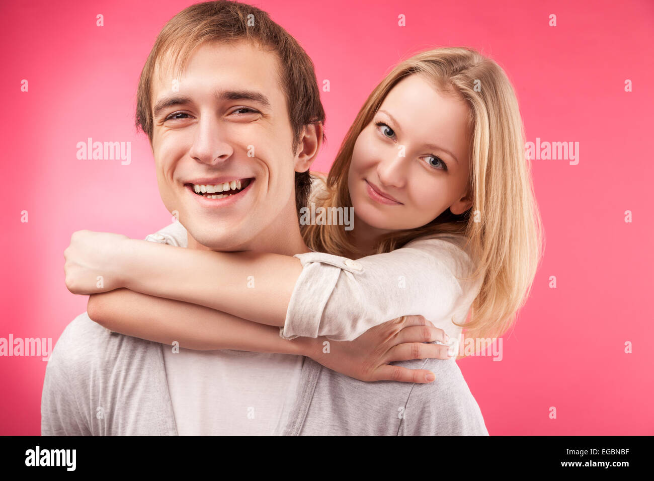 smiling couple hugging, looking in the camera Stock Photo - Alamy