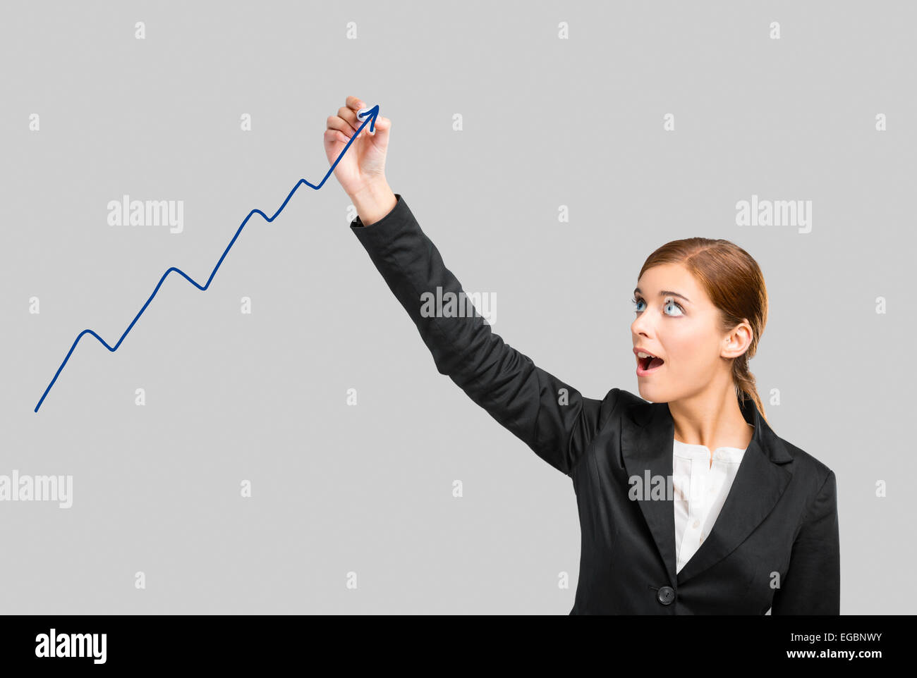 Beautiful businesswoman drawing a chart on a glass board Stock Photo ...