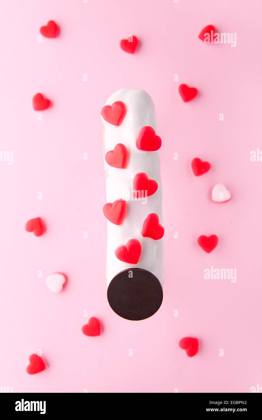 exquisite cream dessert eclair sprinkled with candy in a heart shape ...
