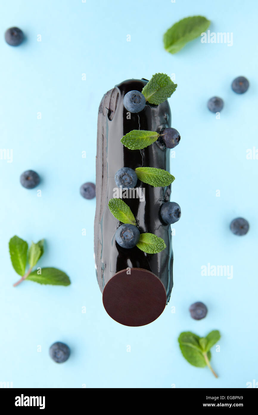 exquisite cream dessert eclair with blueberry and fresh mint leaves ...