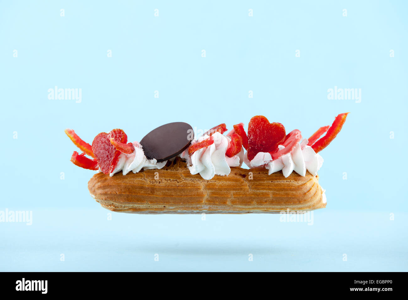 exquisite cream dessert eclair with candied fruit Stock Photo - Alamy