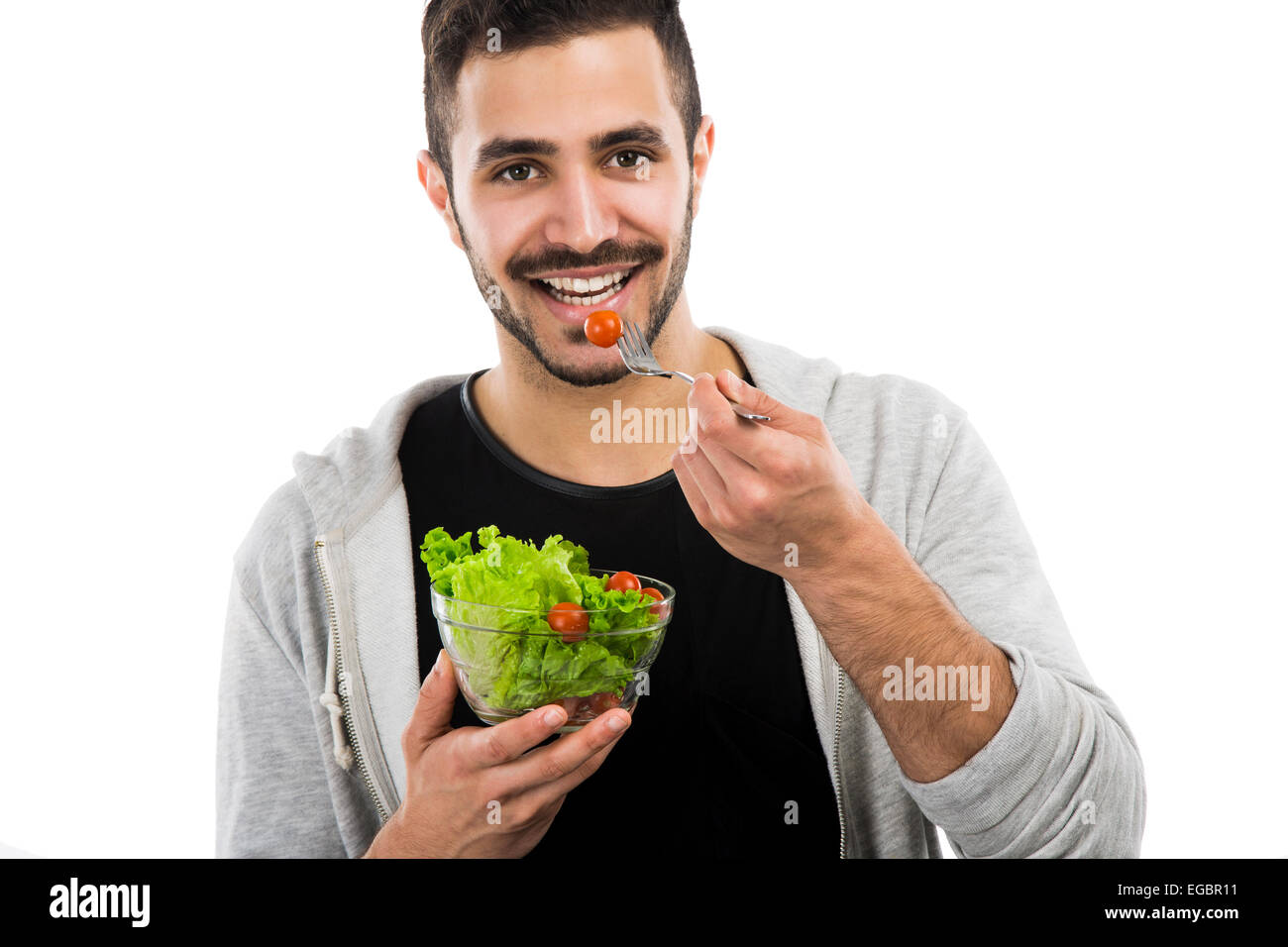 Happy young man eating a salad, isolated on white background Stock ...