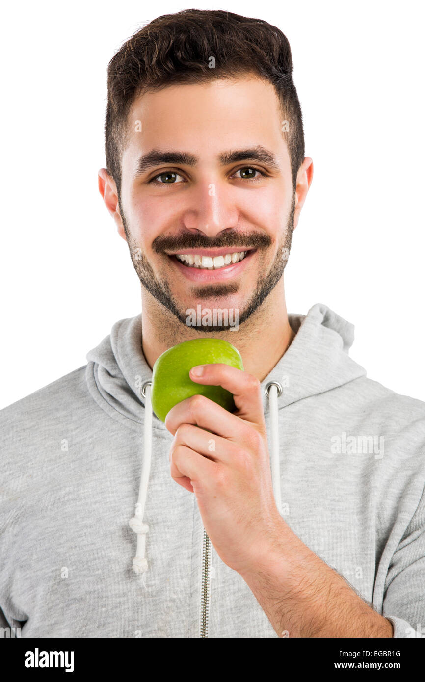 Good looking latin man eating a green apple, isolated on white ...
