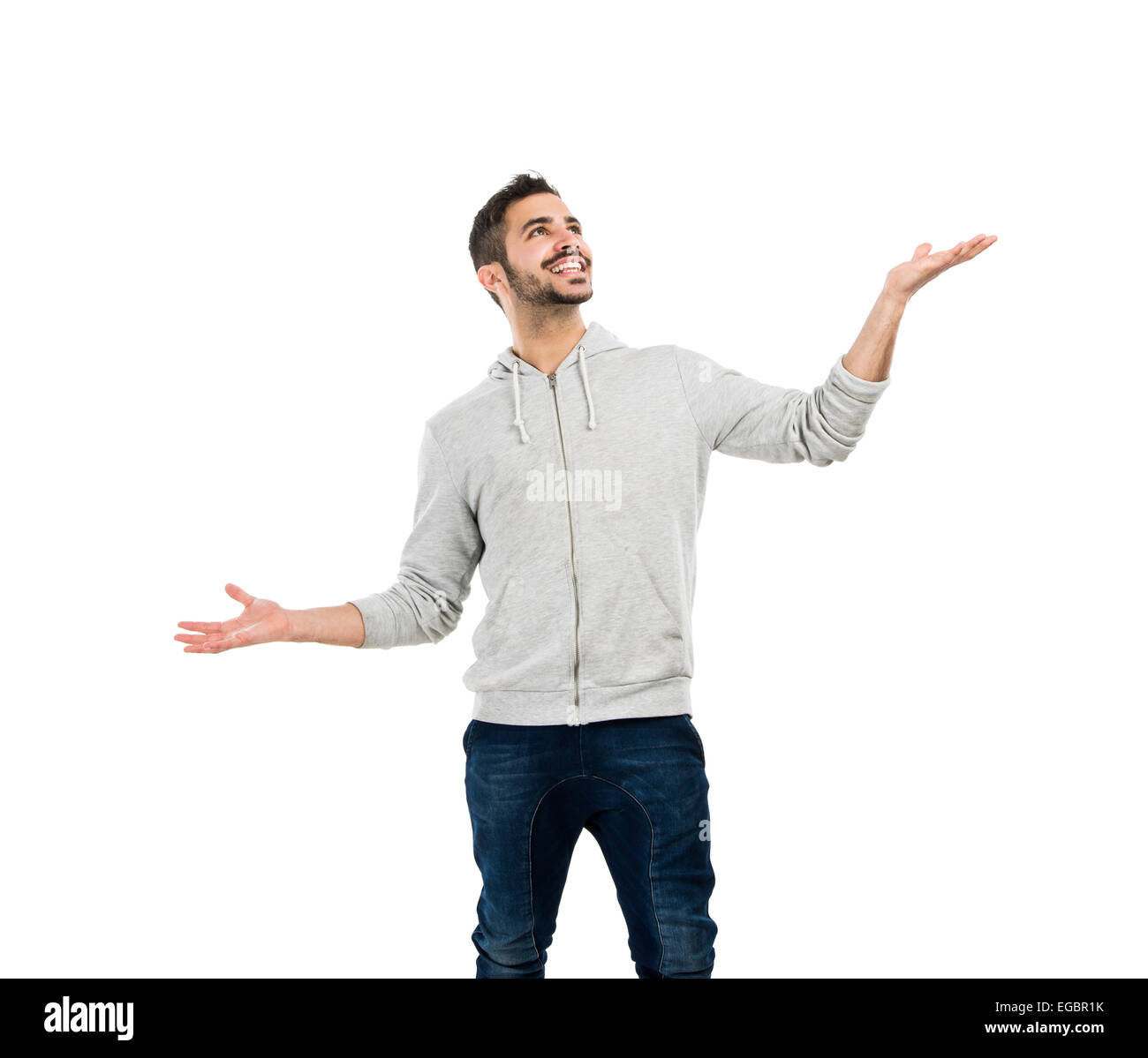 Good looking young man catching something with is hands, with copy ...