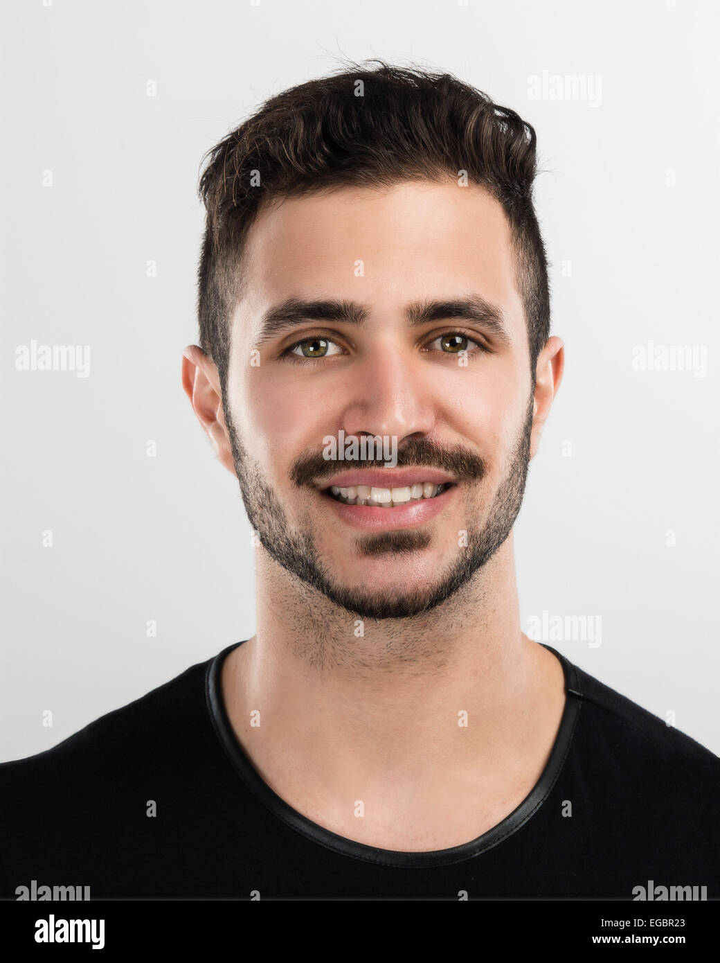 Studio portrait of a handsome young man smiling Stock Photo - Alamy