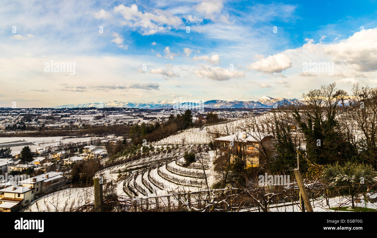a light snowfall on the italian countryside, with white fields and ...