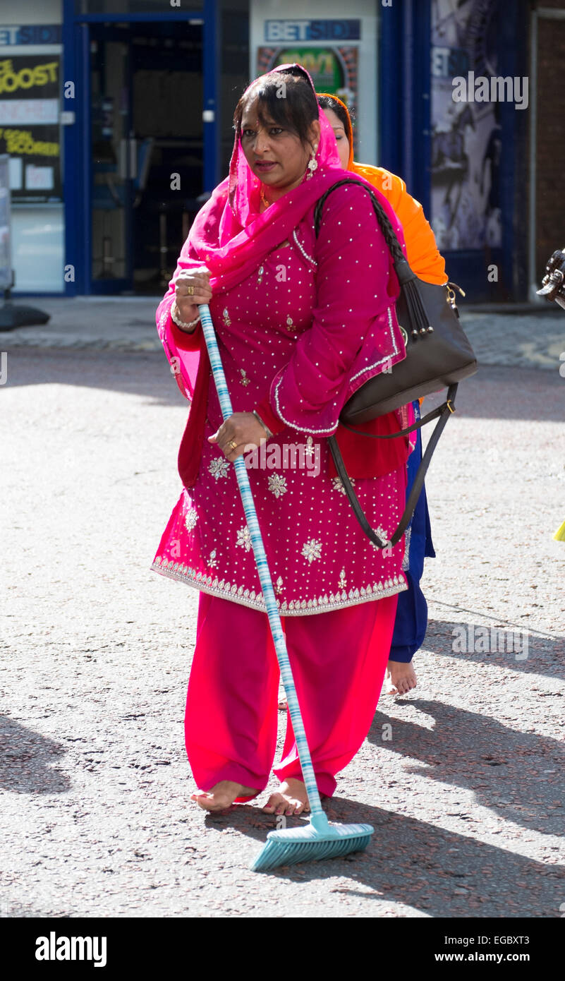 Sikh women clean the floor ahead of religious procession Stock Photo ...