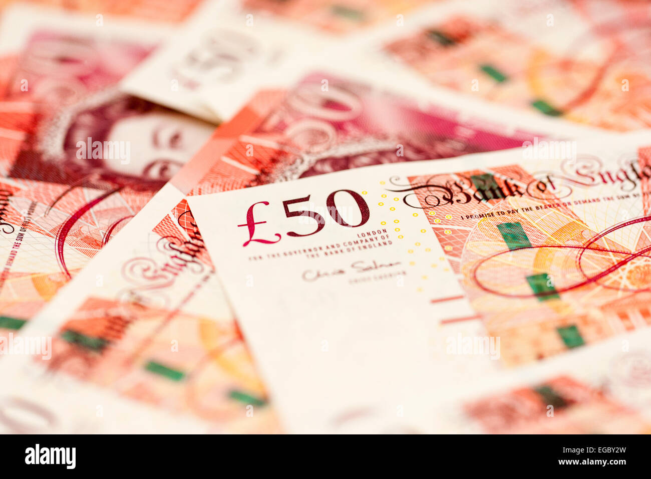 Scattered pile of British £50 sterling banknotes of the new type issued ...
