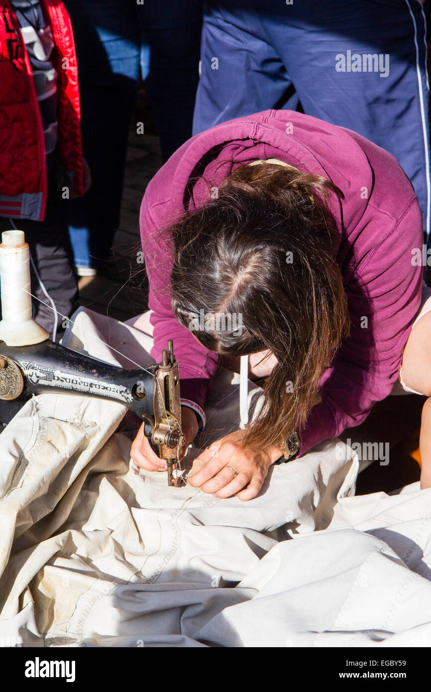 Young woman sitting on the deck of a replica sailing ship, the ...