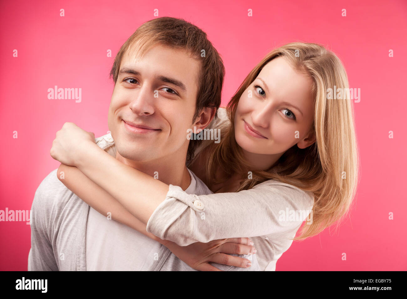 smiling couple hugging, looking in the camera Stock Photo - Alamy