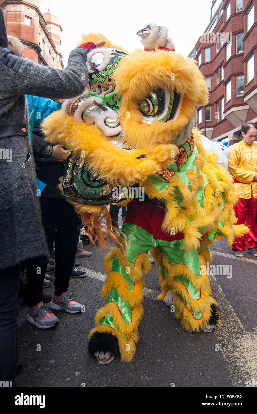 London, UK. 22nd February, 2015. A lion dancer receives a pat on the ...