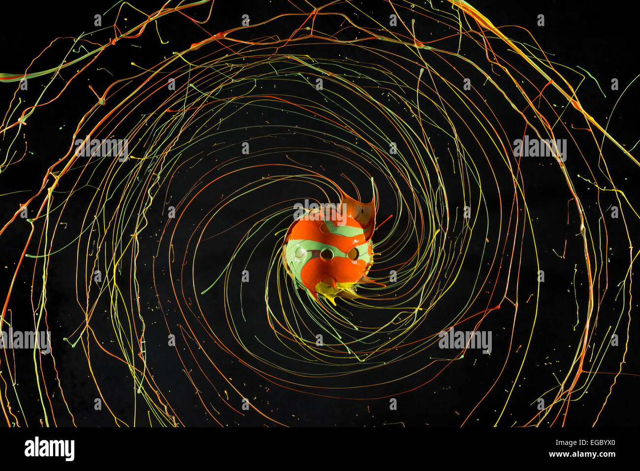 high speed spinning streaming trails of color liquid make spiral shape ...