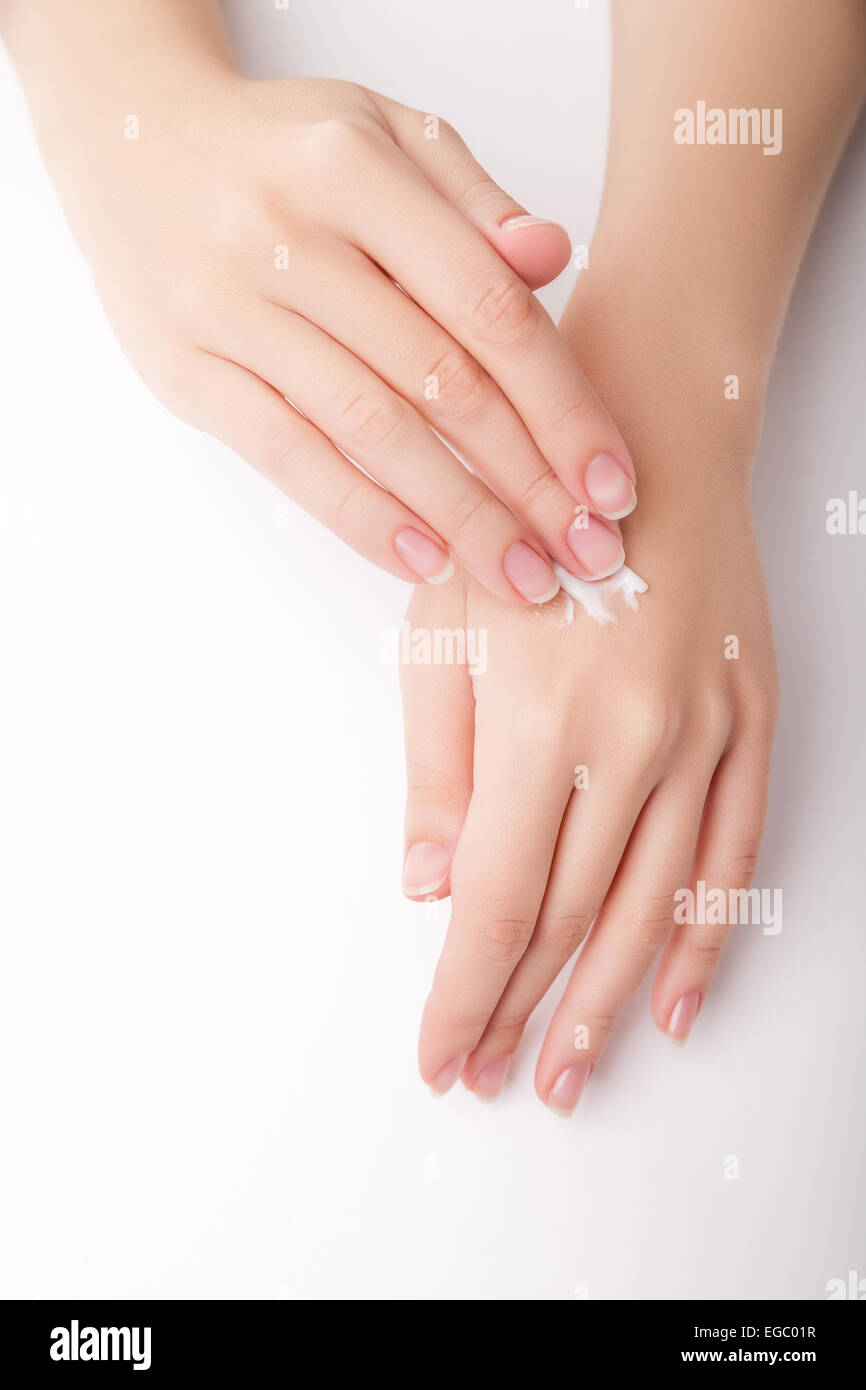Beautiful young woman hands with cream Stock Photo - Alamy
