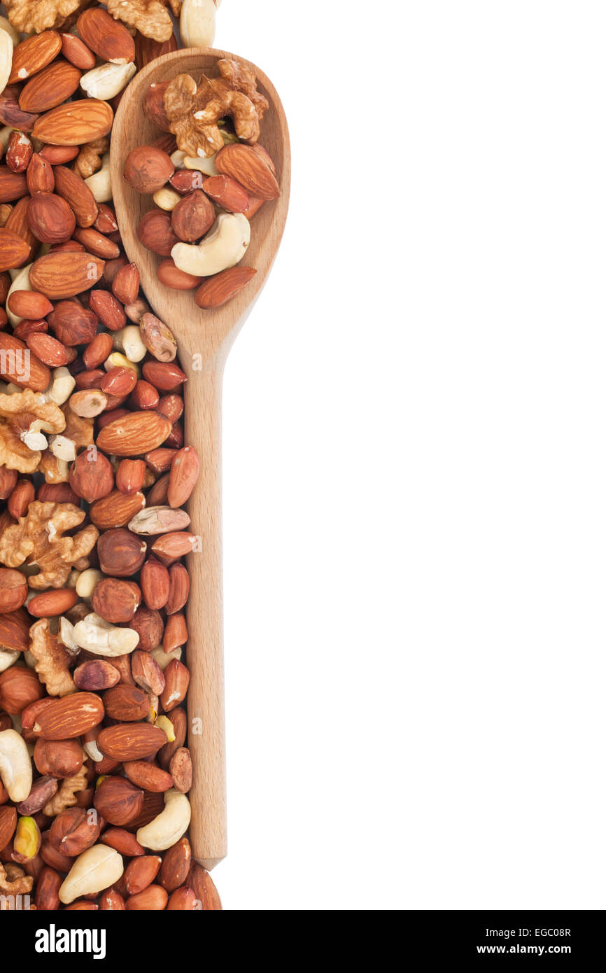 Wooden spoon with nuts, isolated on a white background Stock Photo - Alamy