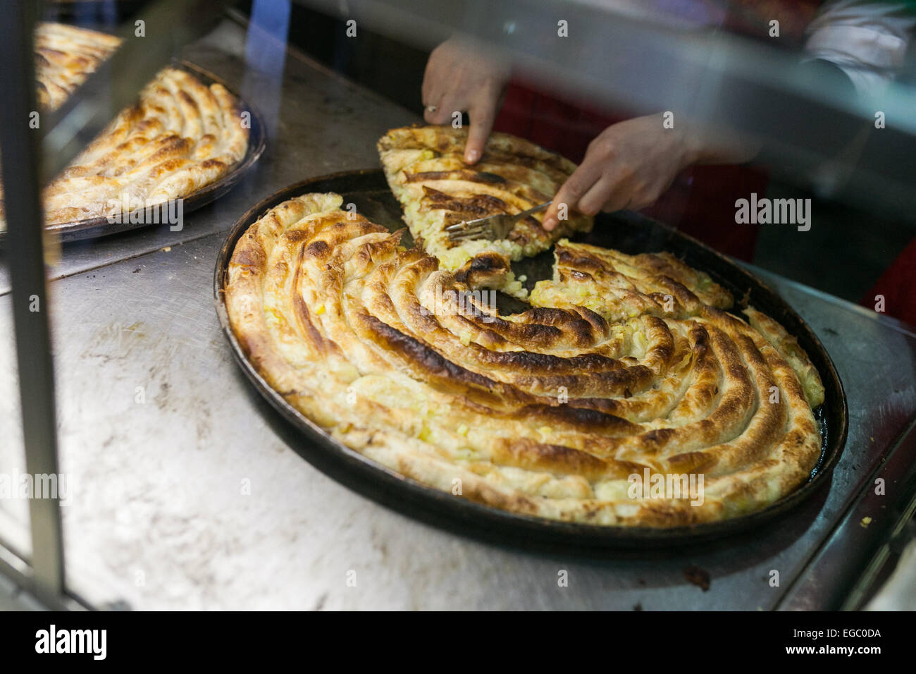 A hot burek, pastry dough filled with beef in buregdzinica Saca in ...