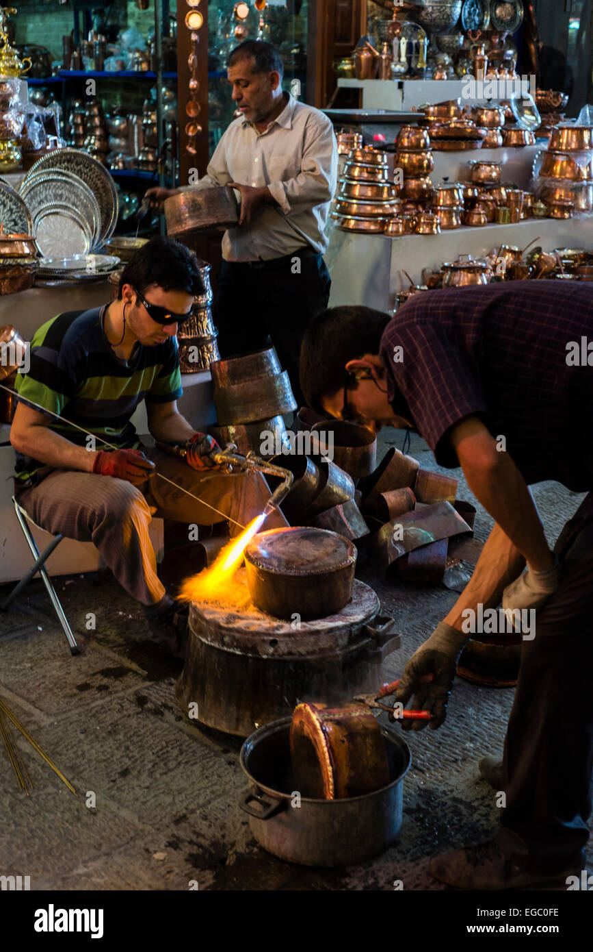 Worker burns cooper pan in process of chasing, Esfahan, Iran Stock ...