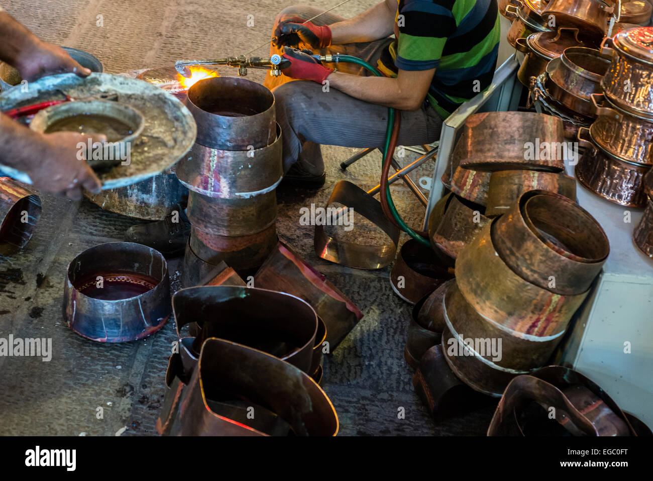 Worker burns cooper pan in process of chasing, Esfahan, Iran Stock ...