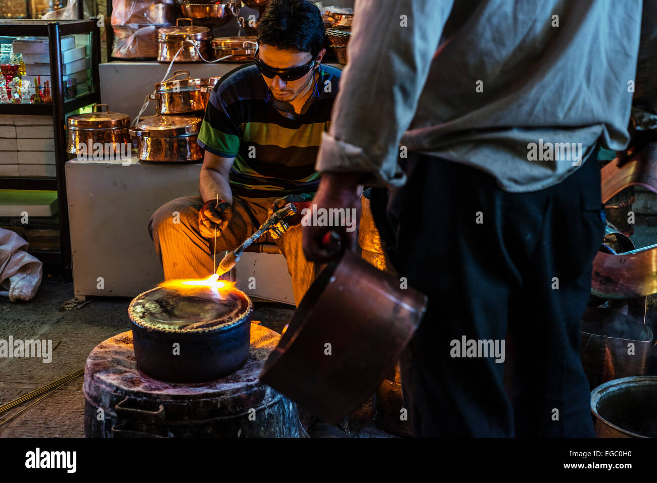 Worker burns cooper pan in process of chasing, Esfahan, Iran Stock ...