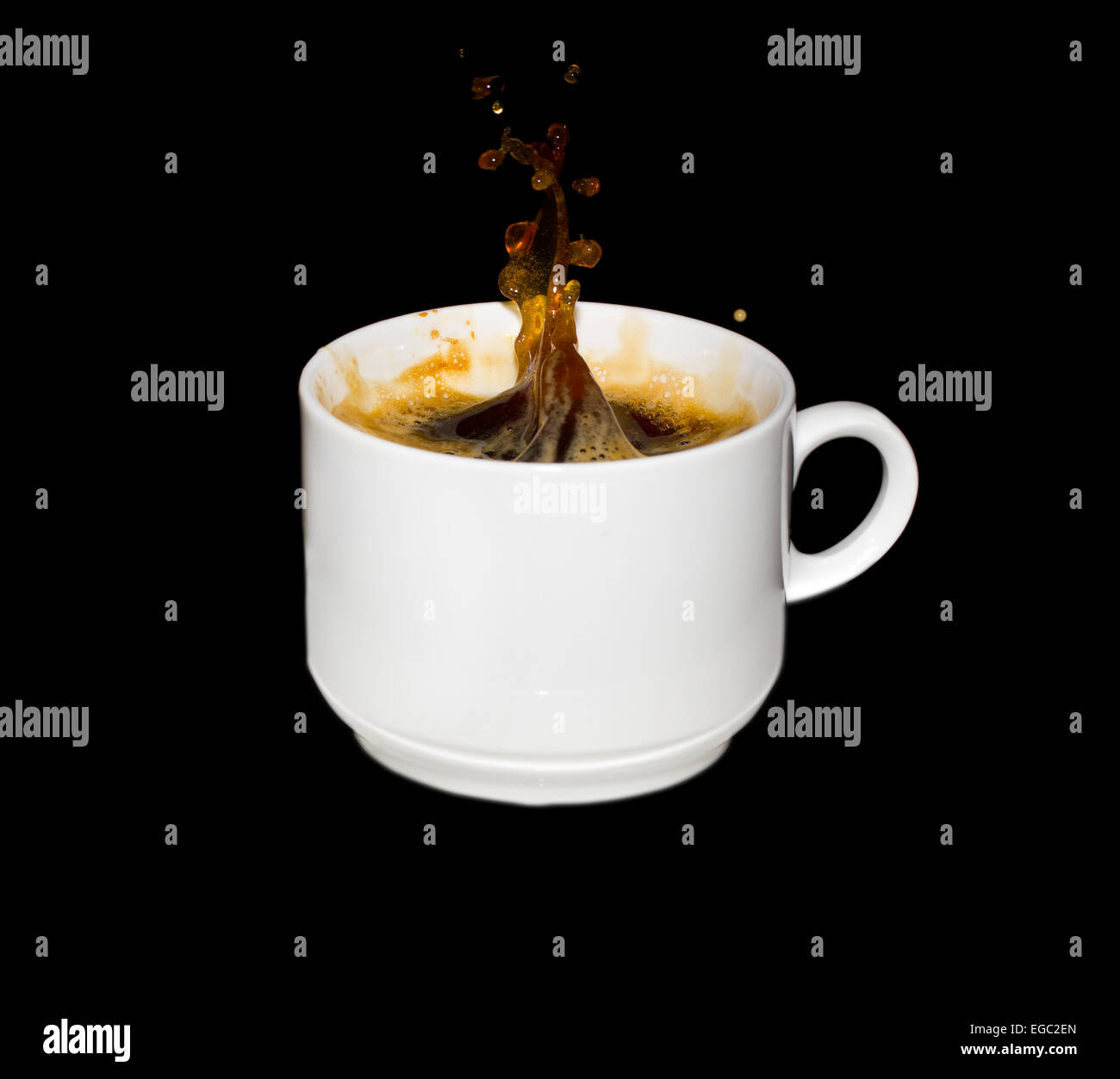 Sugar cube dropped into a cup of coffee isolated on a black background ...