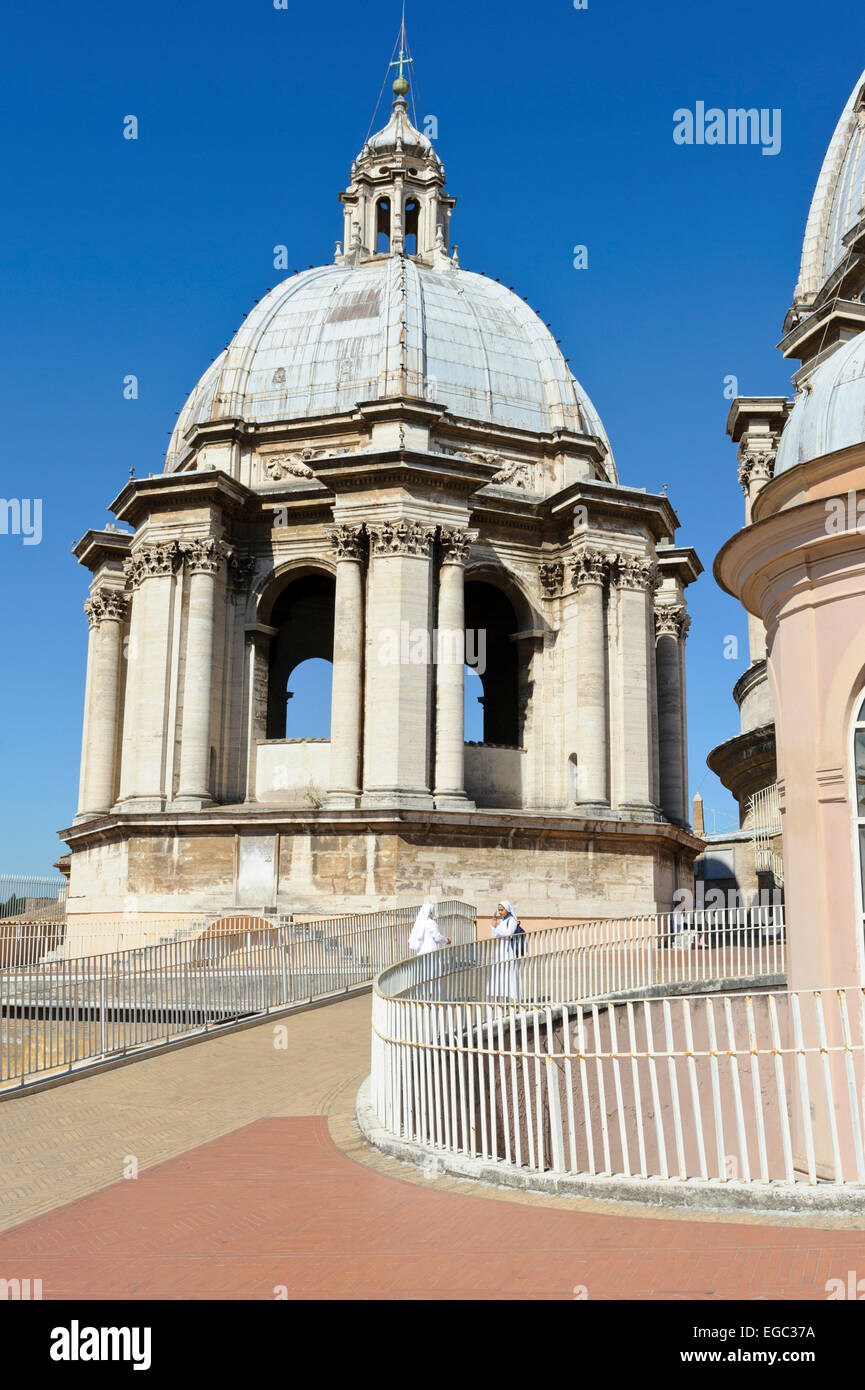 Two nuns in white robe talking on the rooftop of St Peter's Basilica ...