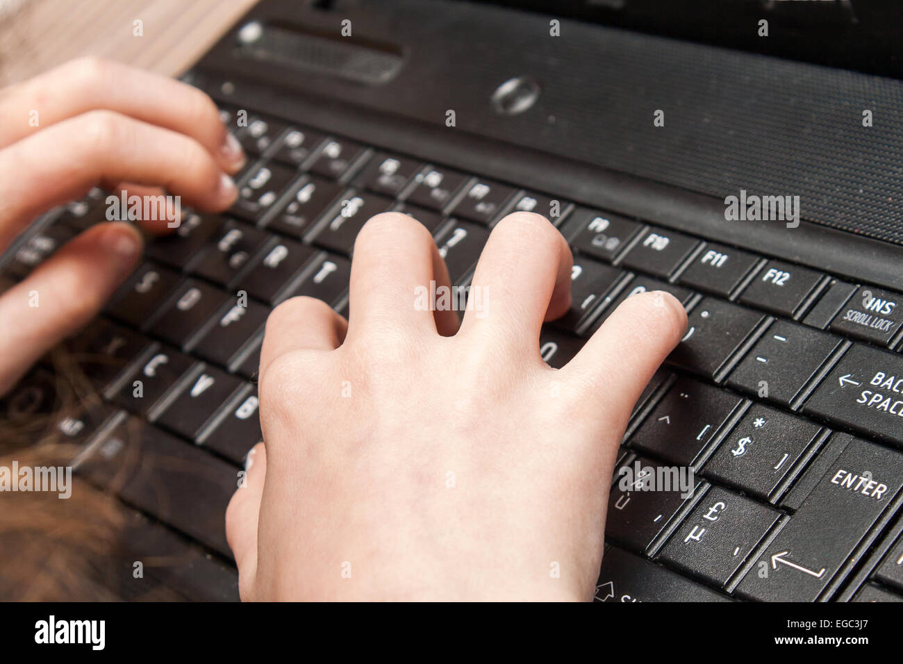 children's hands typing on a laptop keyboard Stock Photo - Alamy