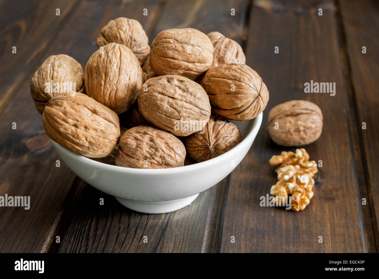 white cup walnuts on old wood background Stock Photo - Alamy