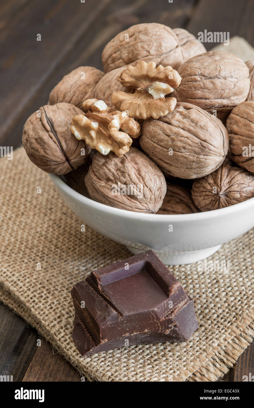 chocolate and walnuts on old wood background Stock Photo - Alamy
