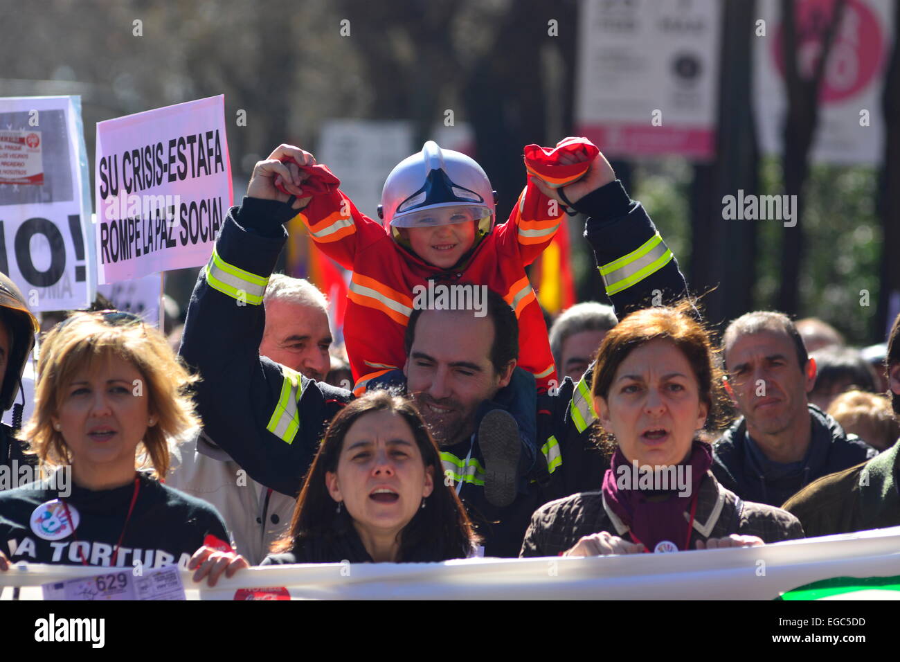 A young boy dressed with firefighter clothes during a demonstration ...