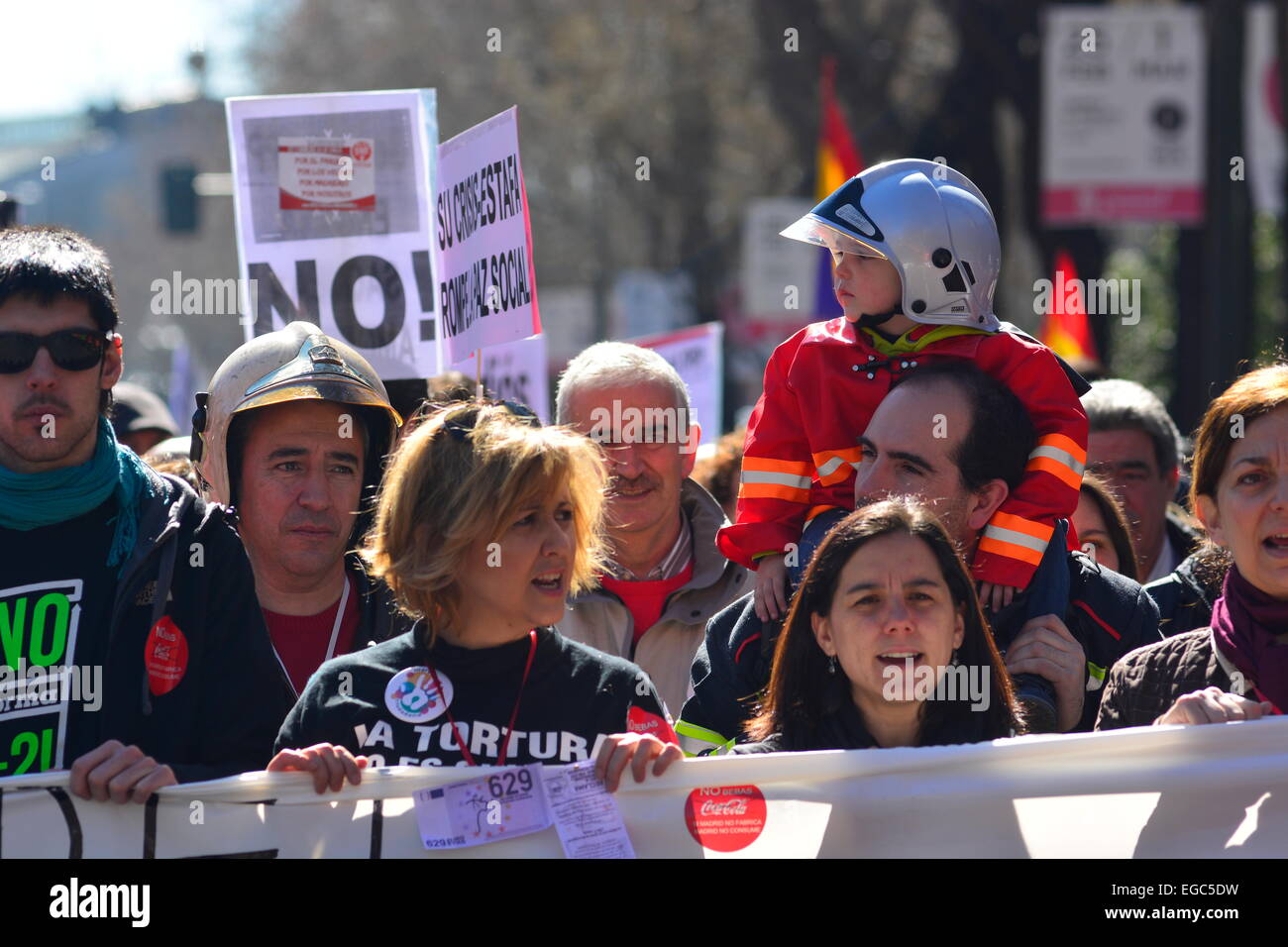 A young boy dressed with firefighter clothes during a demonstration ...