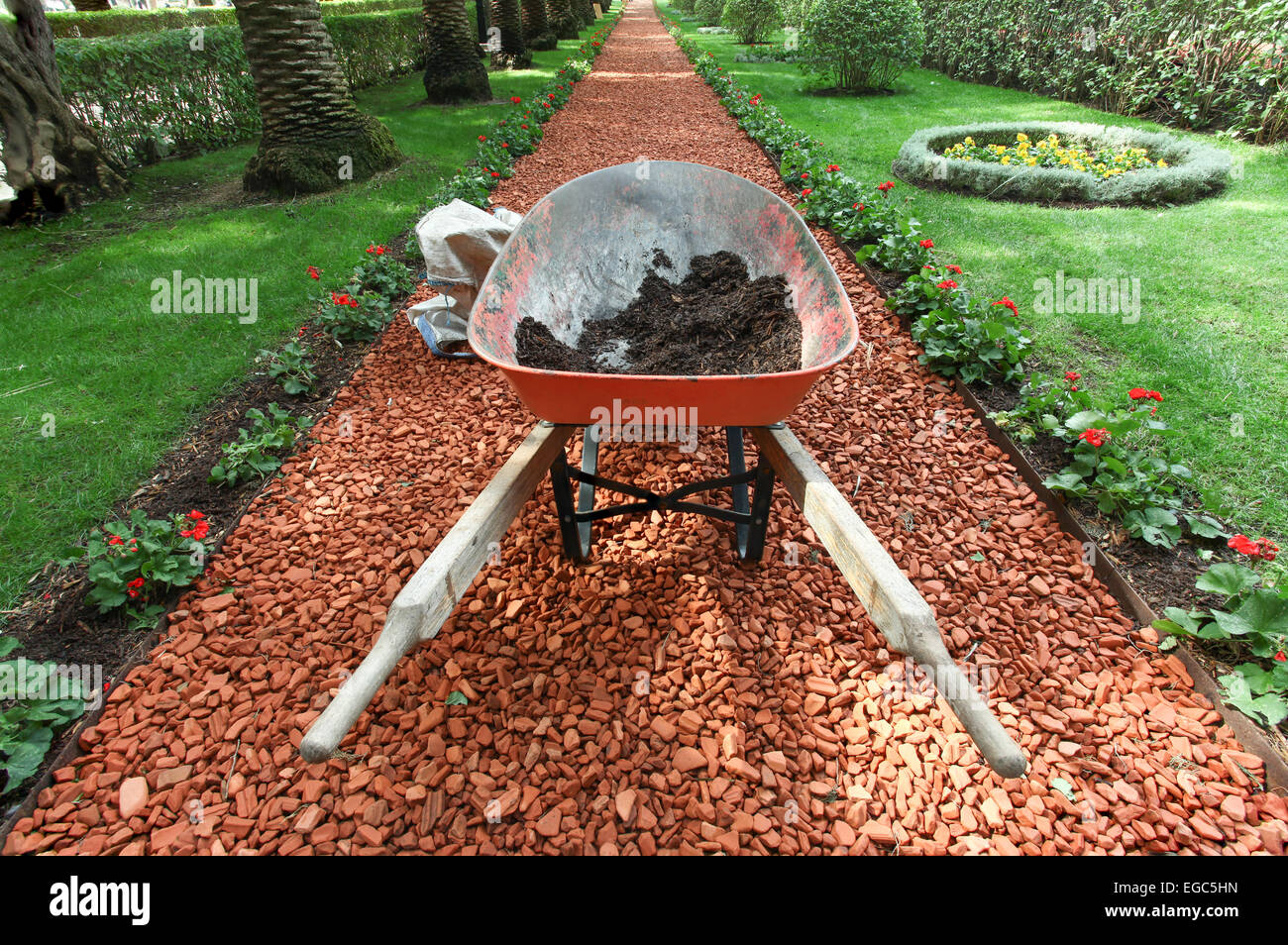 Garden work concept with wheelbarrow, soil and beautiful garden Stock ...