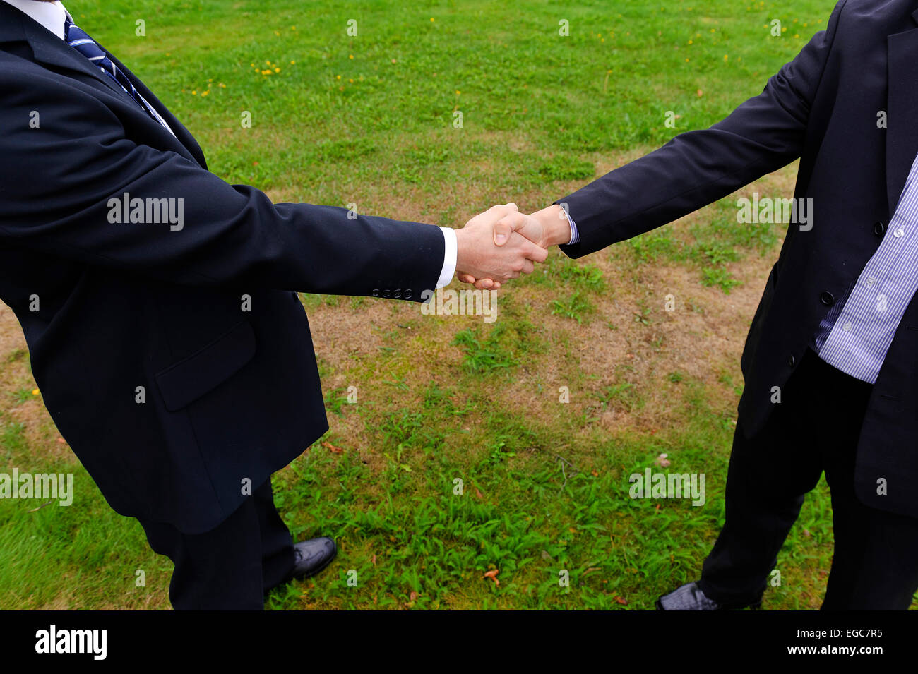 Handshake of two businessmen in suits Stock Photo - Alamy