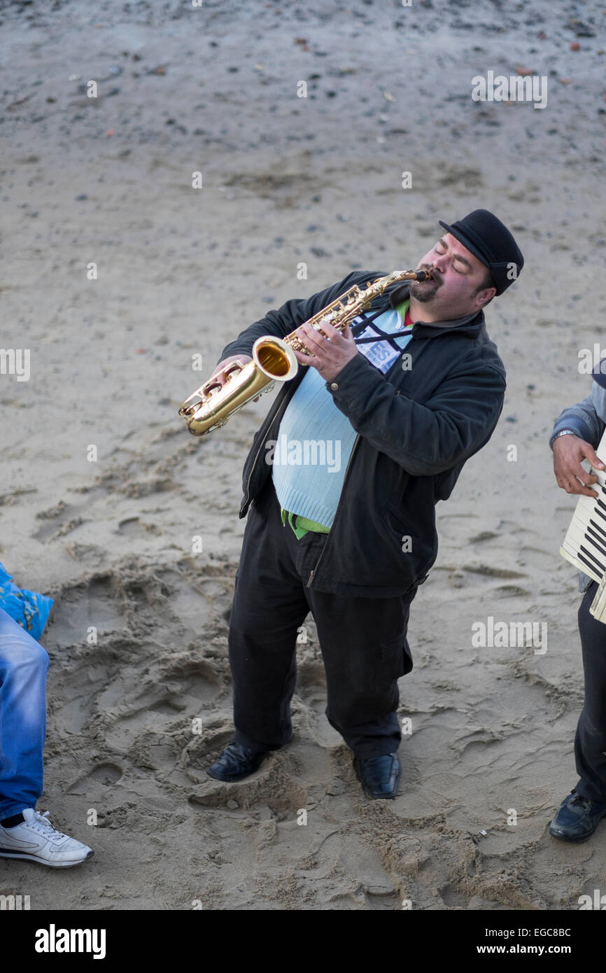 Eastern Europeans busking on the bank of the River Thames in London's ...