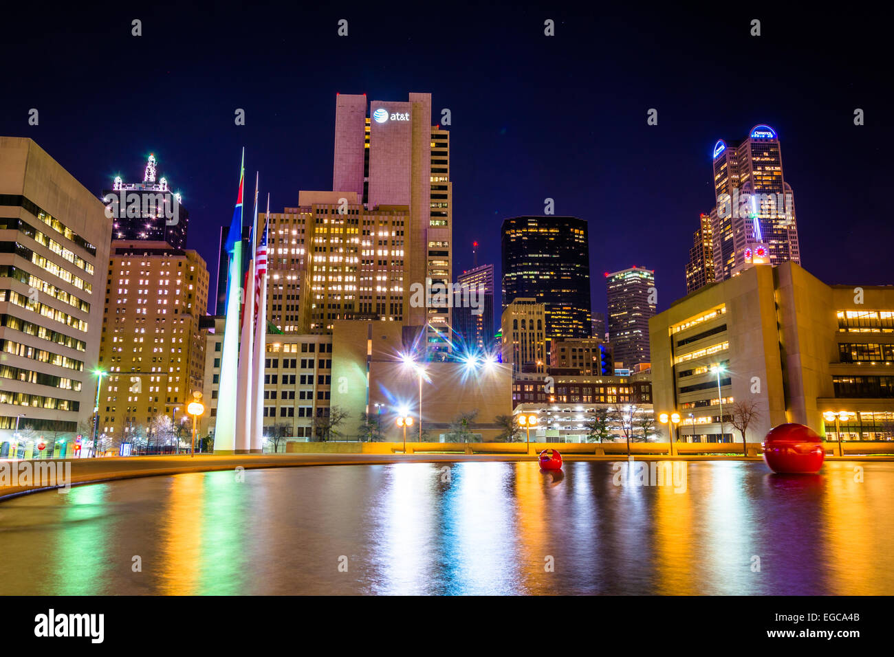 The Dallas skyline and the reflecting pool at City Hall at night, in ...