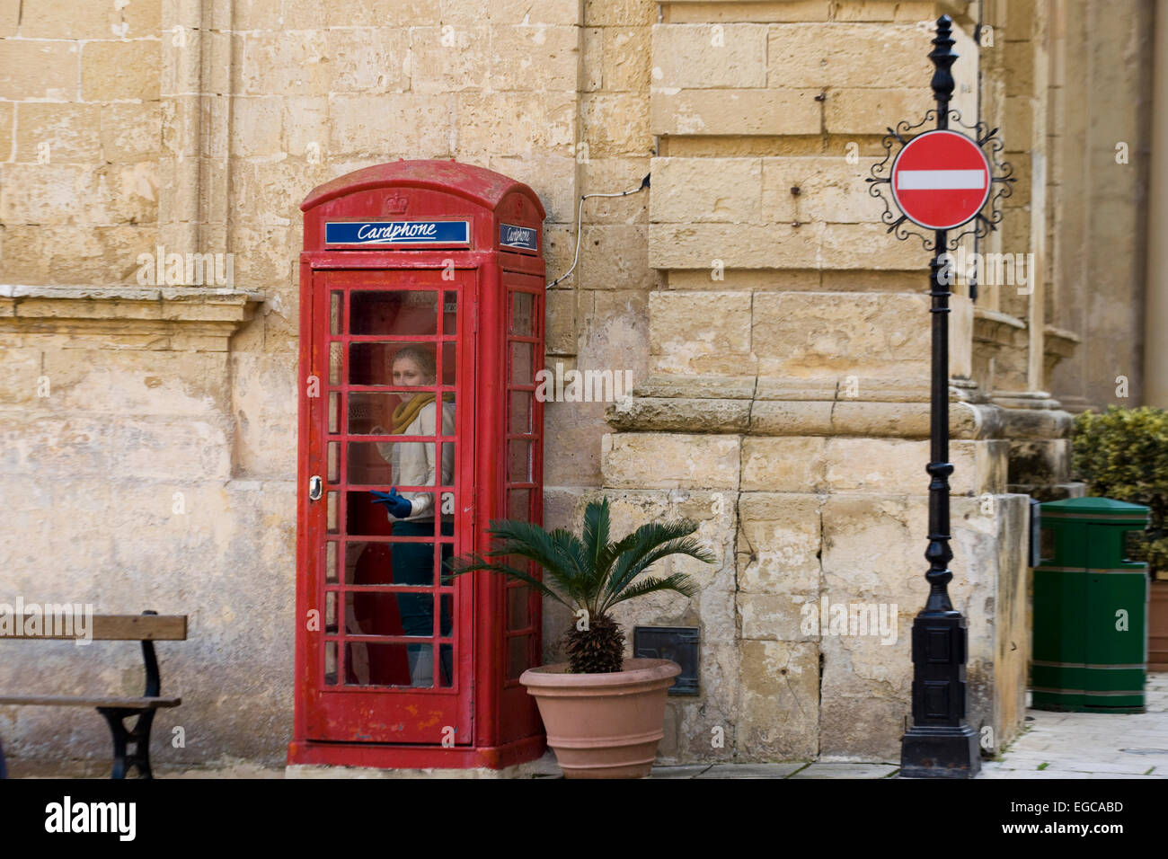 Tourist in a Red Public Telephone Box in Malta Stock Photo - Alamy