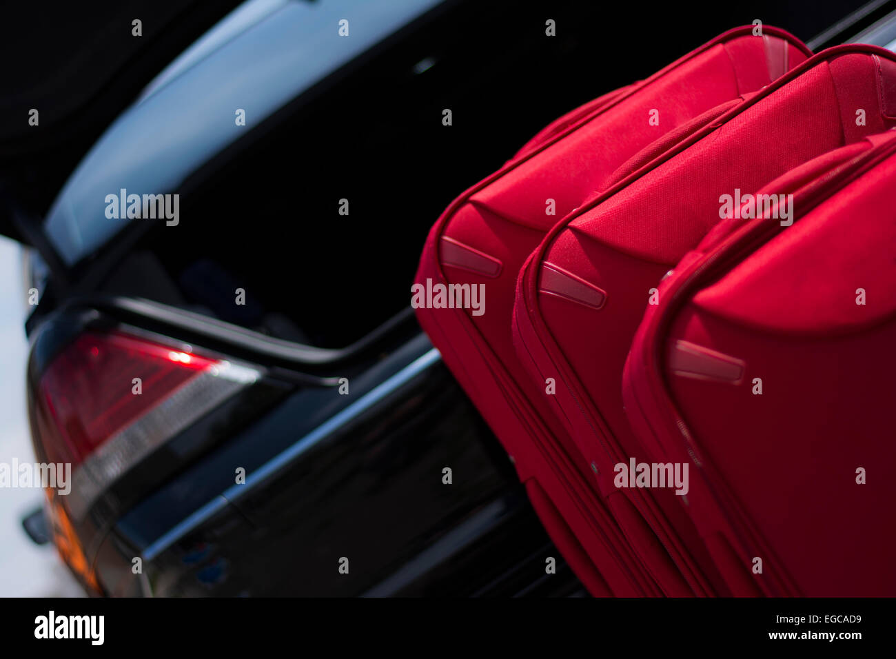 Red suitcases in front of the car trunk ready for travel Stock Photo ...
