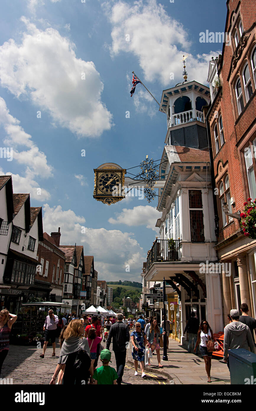 Shoppers in Guildford High Street and the town clock projecting from ...