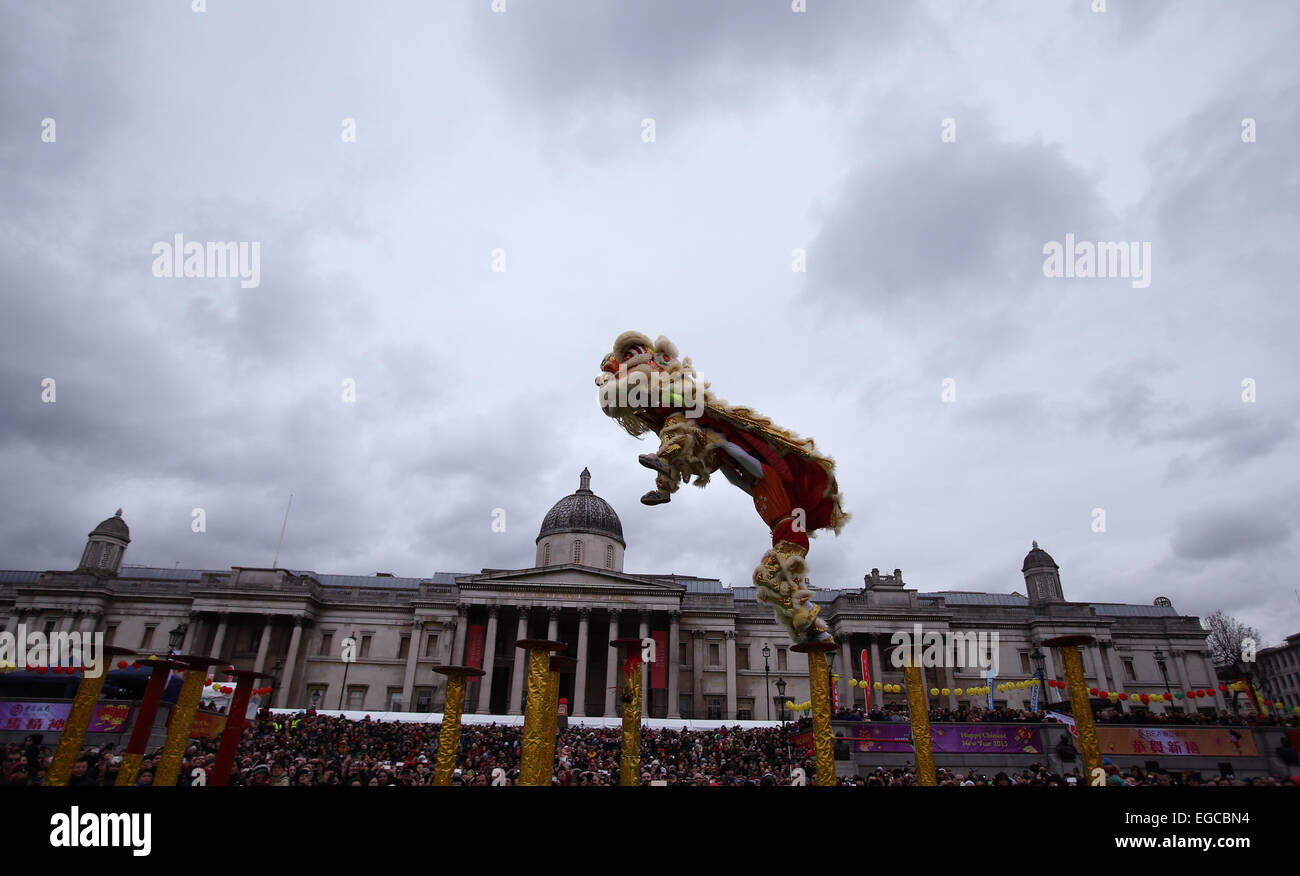 London, Britain. 22nd Feb, 2015. Performers in a lion costume jump ...