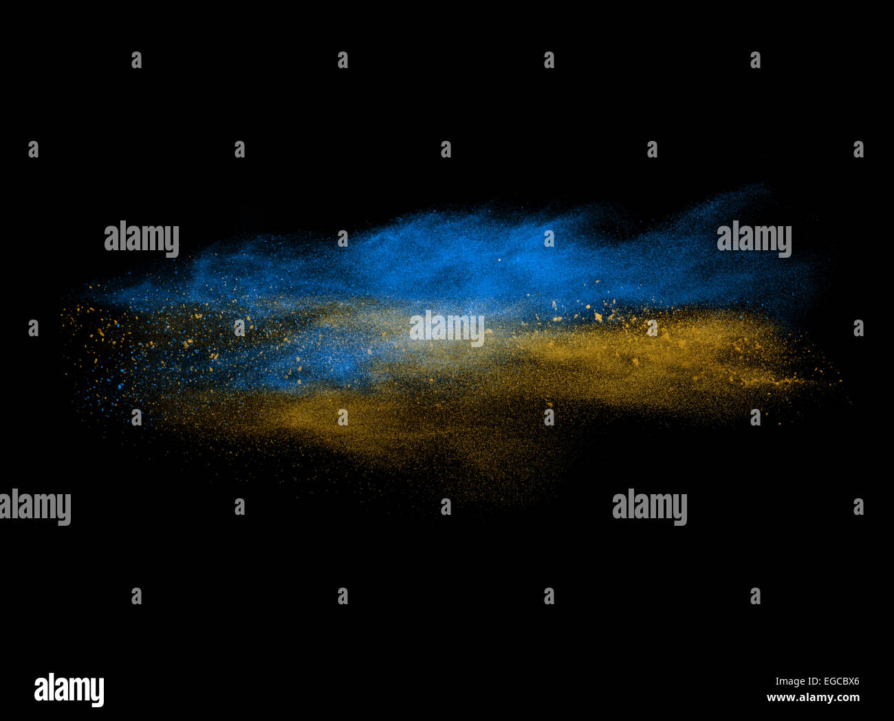 Blue and yellow powder explosion isolated on black Stock Photo - Alamy