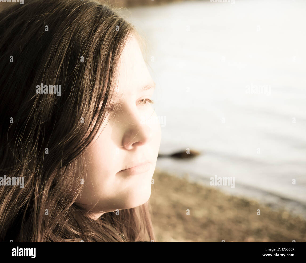 Young girl portrait looking past camera into distance Stock Photo - Alamy