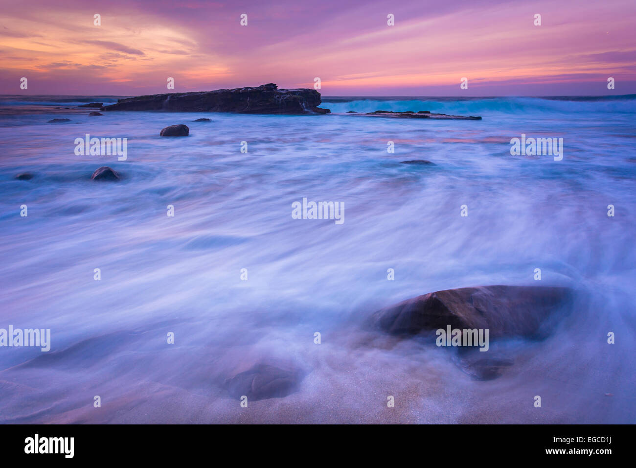 Waves and rocks in the Pacific Ocean at sunset, seen at Shell Beach, in ...