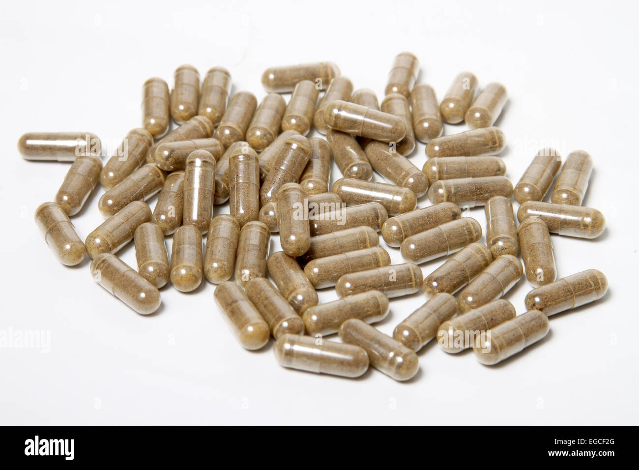 Capsules of green herbal supplements with natural clear coating used in ...